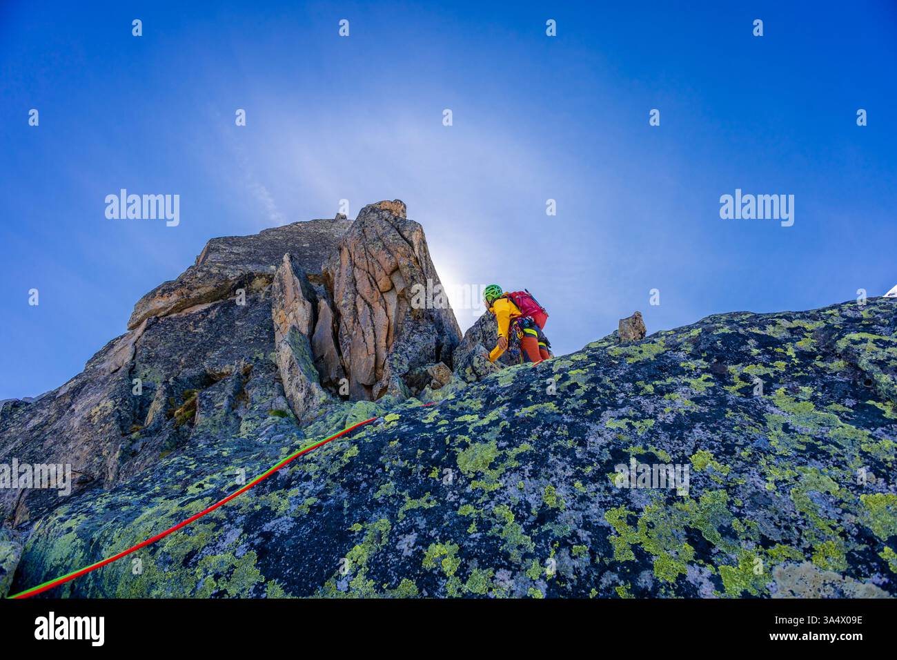 Alpinists climbing granite mountain walls in the Alps. Difficult alpine ...