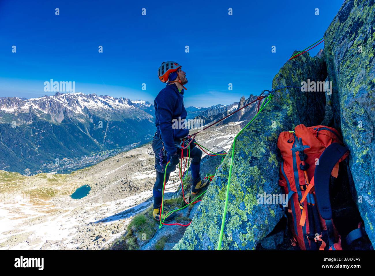 Alpinists climbing granite mountain walls in the Alps. Difficult alpine ...