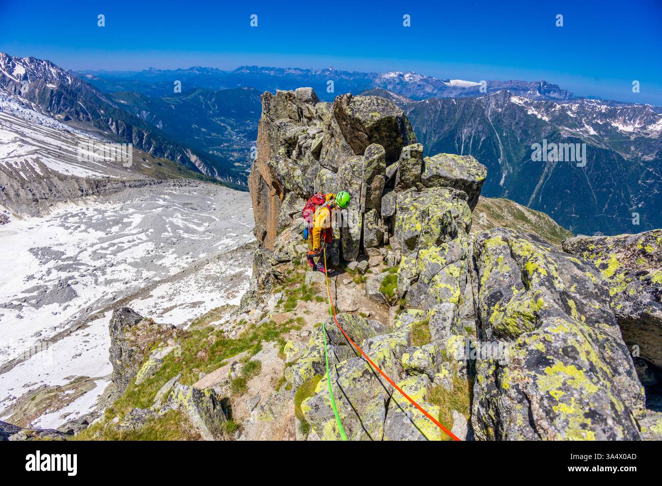 Alpinists climbing granite mountain walls in the Alps. Difficult alpine ...