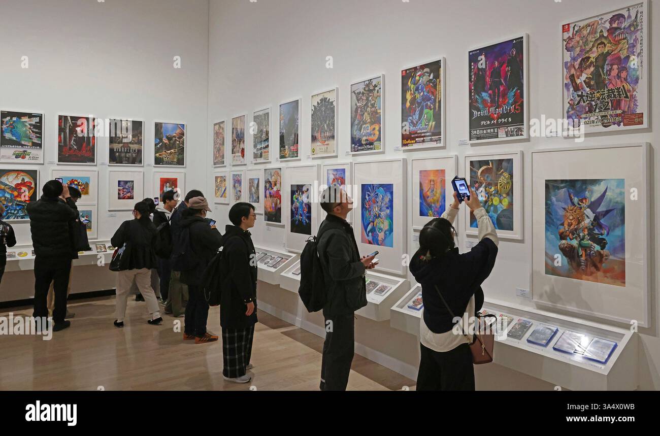 Visitors gaze the poster's main art of "Capcom Creation –moving hearts ...