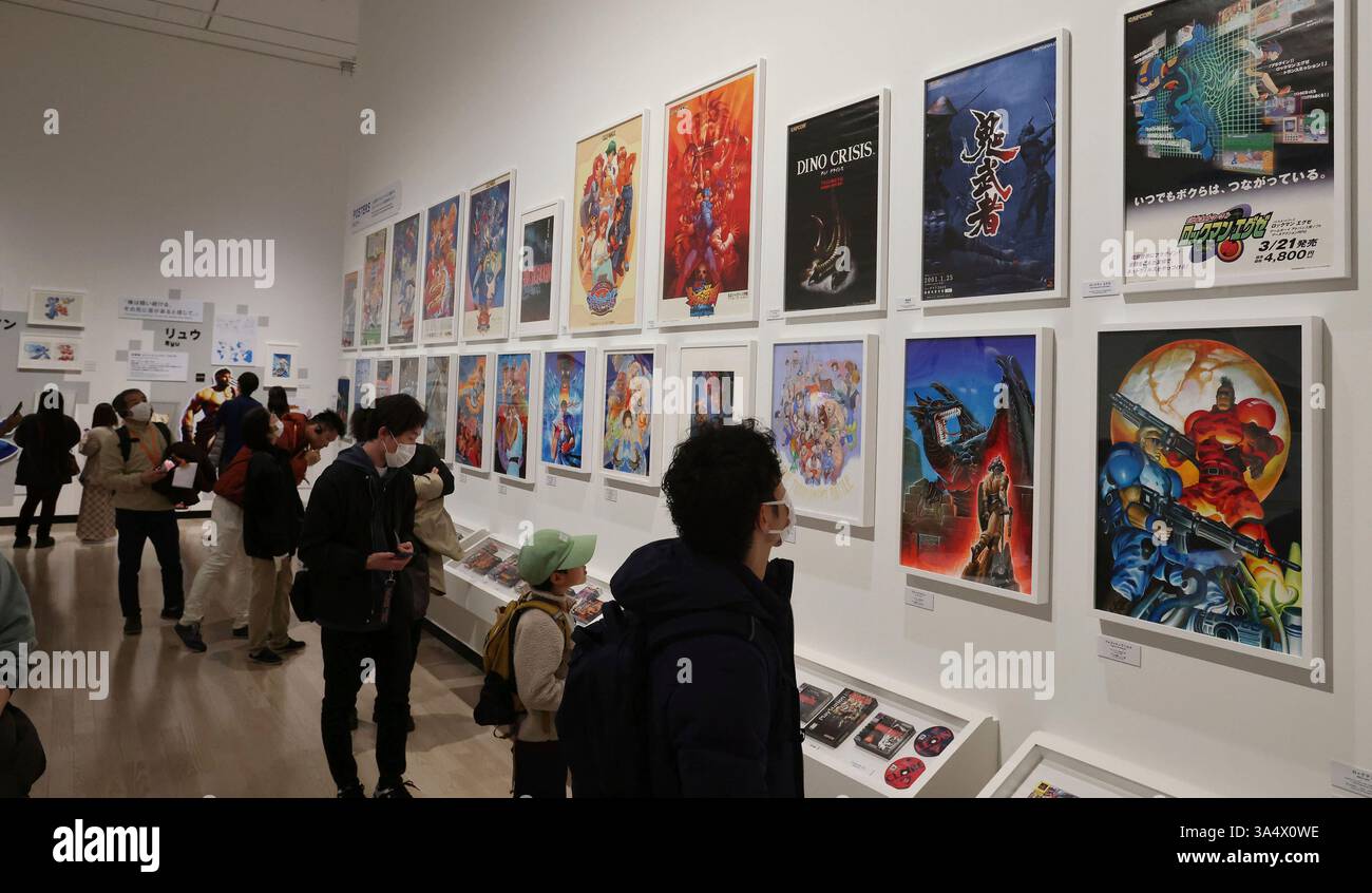 Visitors gaze the poster's main art of "Capcom Creation –moving hearts ...