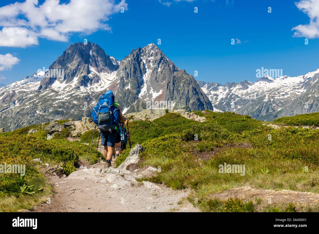 Alpinists climbing granite mountain walls in the Alps. Difficult alpine ...