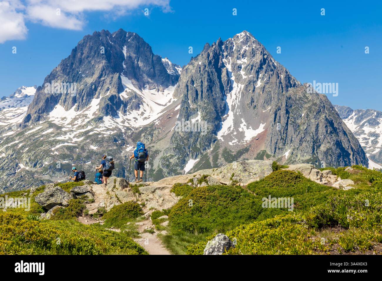 Alpinists climbing granite mountain walls in the Alps. Difficult alpine ...