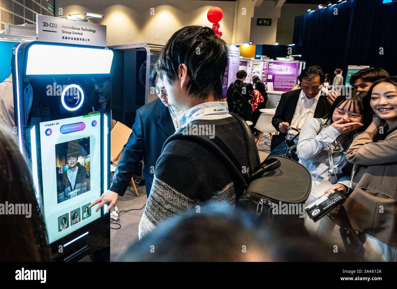 Hong Kong,China.19th March 2025. A visitor tries artificial intelligence (AI) image design on ...