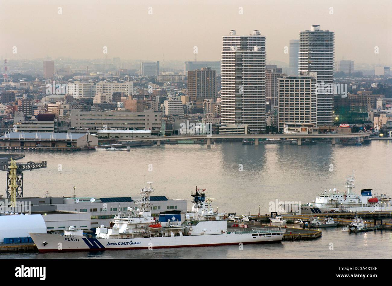 Aerial skyline view of Yokohama Bay, high-rise buildings and urban sprawl along waterfront of ...