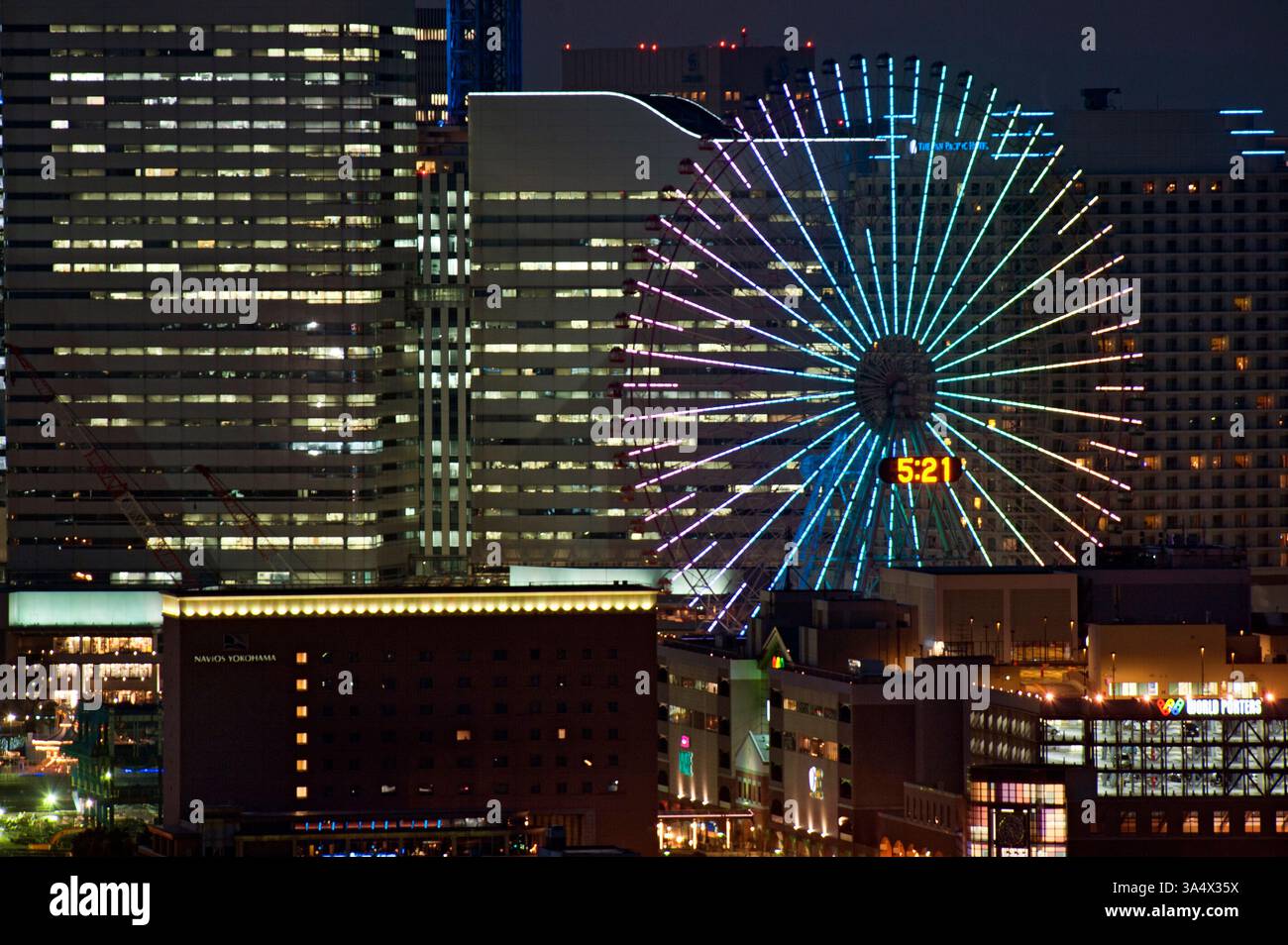 Multi-colored Clock Ferris wheel at night at the Cosmo World amusement ...