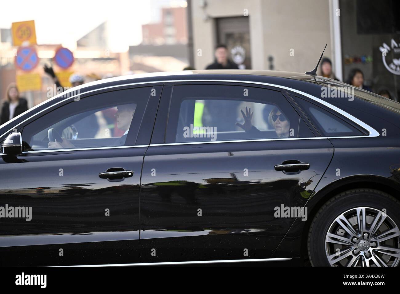 The car carrying Ukrainian President Volodymyr Zelensky (waving) and ...