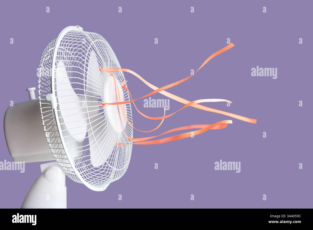 Electric fan with fluttering ribbons on violet background Stock Photo ...
