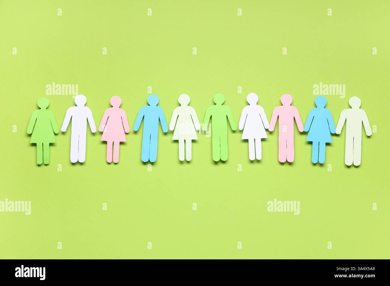 Colorful paper human figures on green background. Diversity and ...