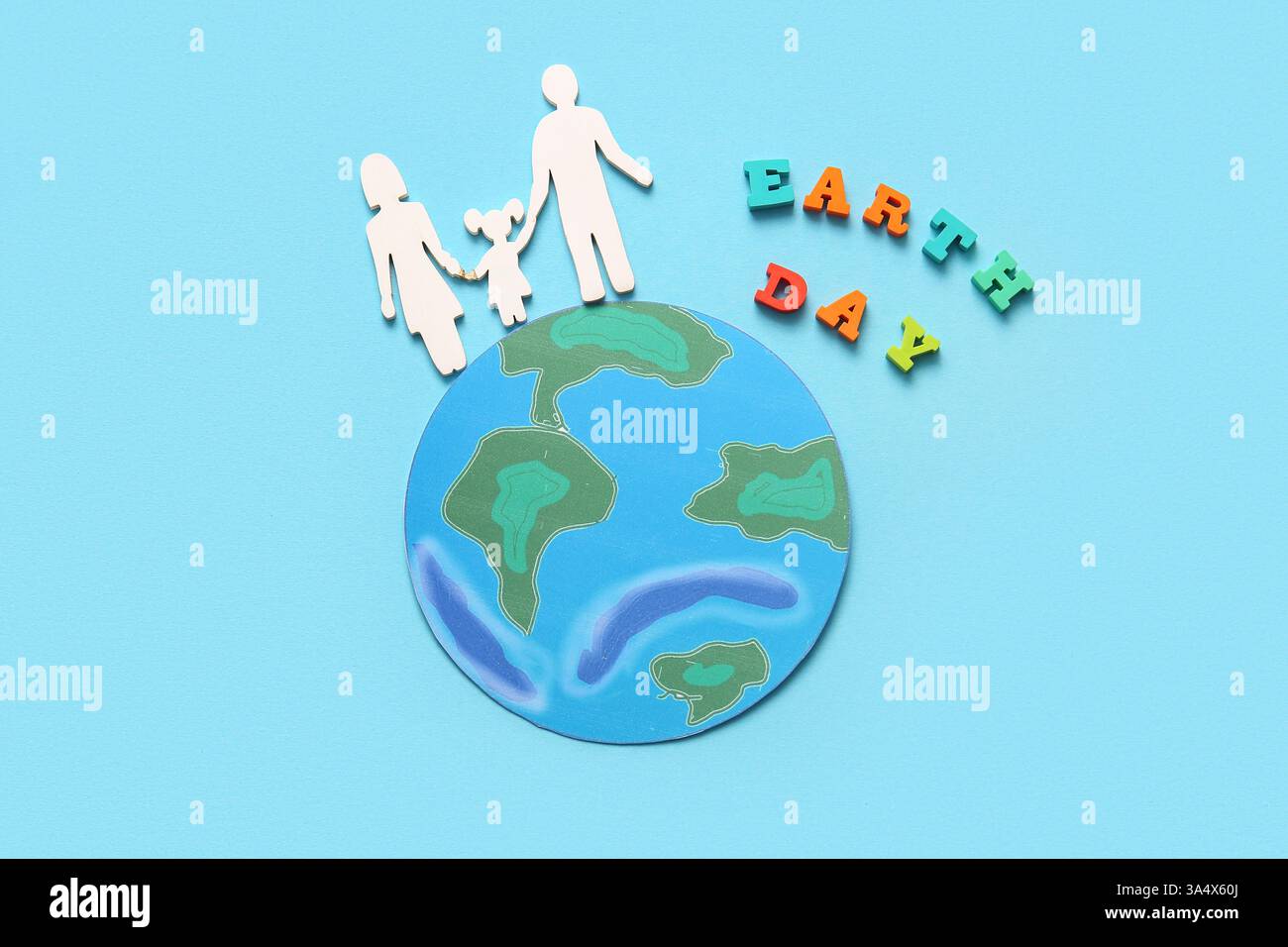 Paper planet Earth with words EARTH DAY and figures of family on blue ...