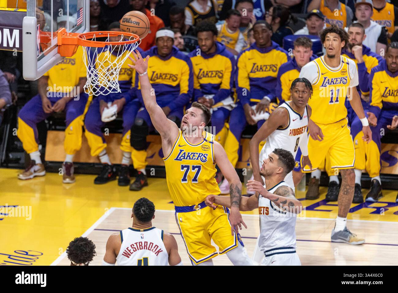 Los Angeles, USA. 19th Mar, 2025. Los Angeles Lakers' Luka Doncic (C) goes for a layup during ...