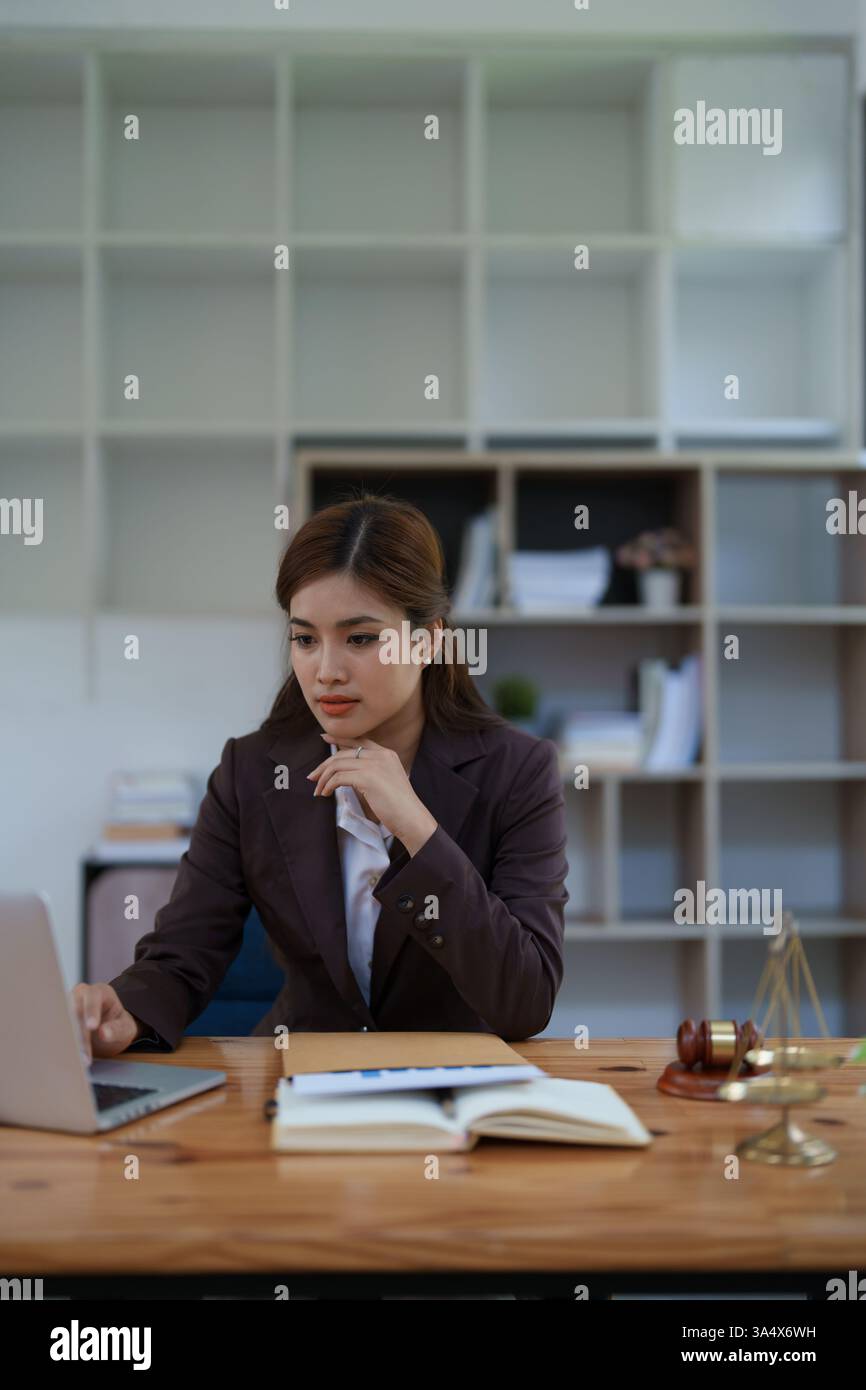 female attorney advisor at a law firm reviews legal documents at her ...