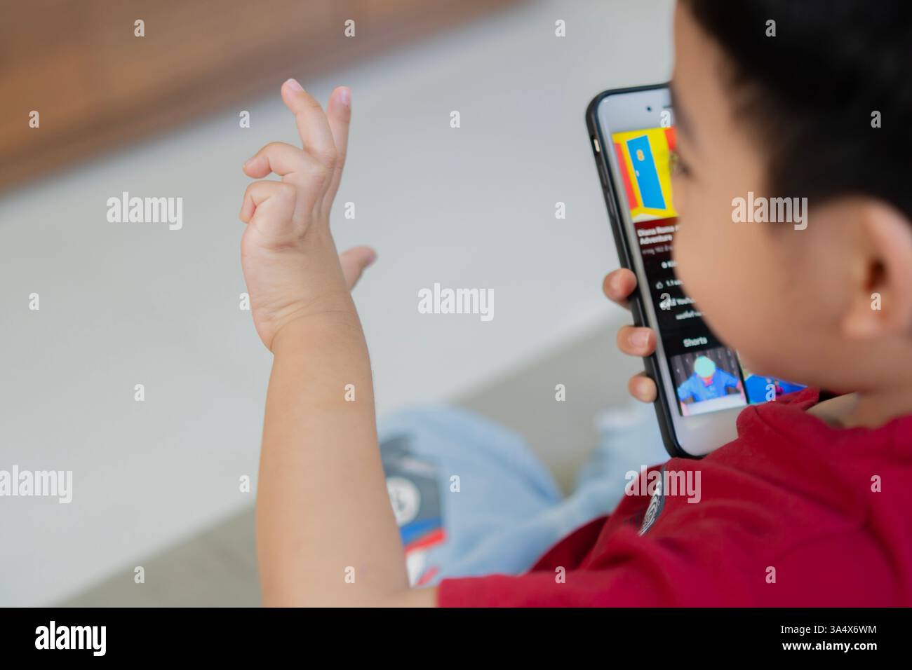 Back view of child boy looking on mobile screen. Educational online ...