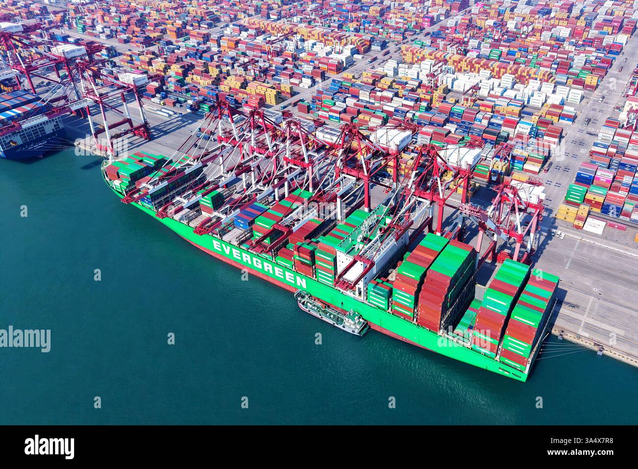 QINGDAO, CHINA - MARCH 20, 2025 - A cargo ship is loading and unloading ...