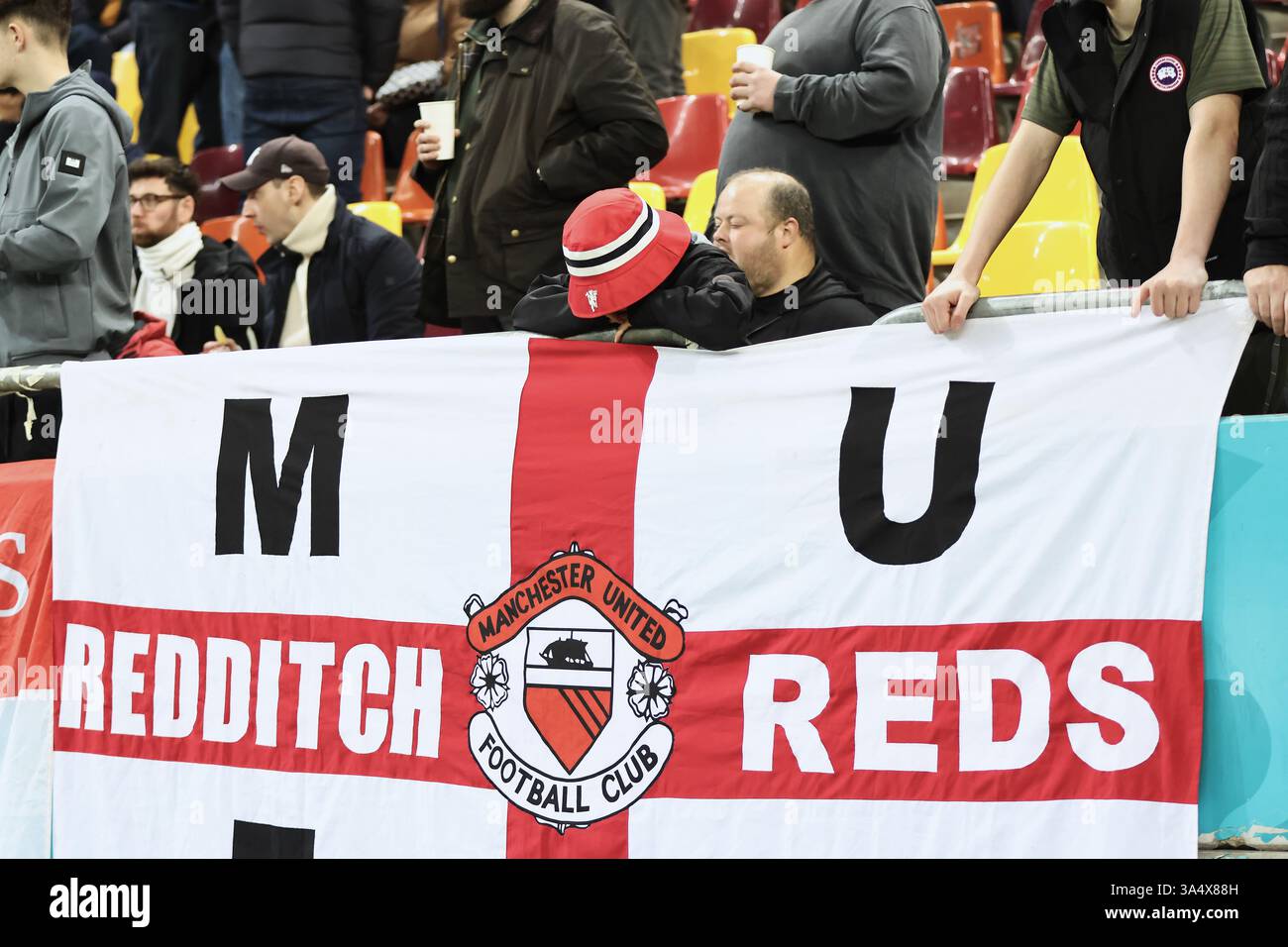Young fan standing above the Manchester United flag during the UEFA ...