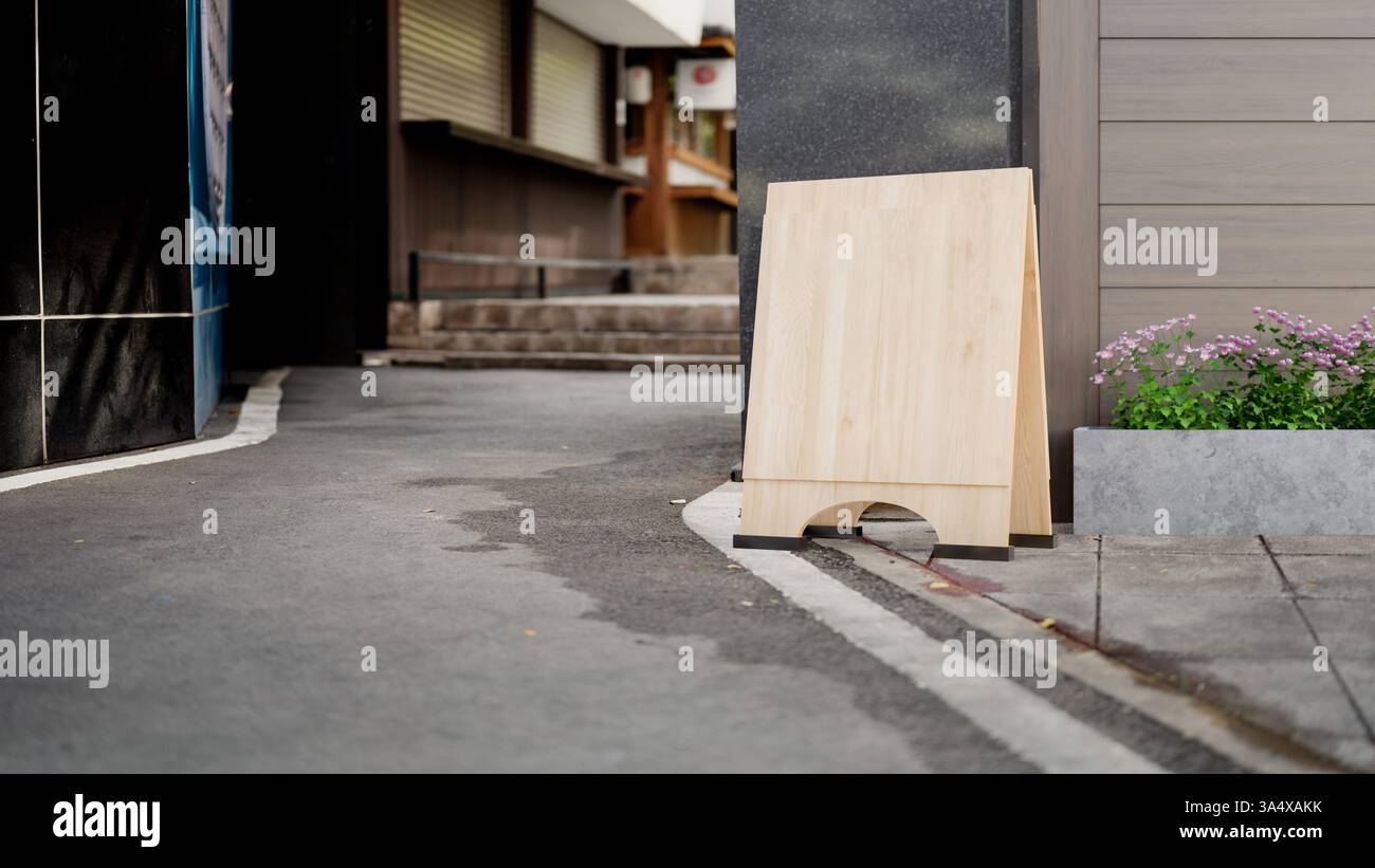 The blank wooden signboard places on the concrete sidewalk in front of ...