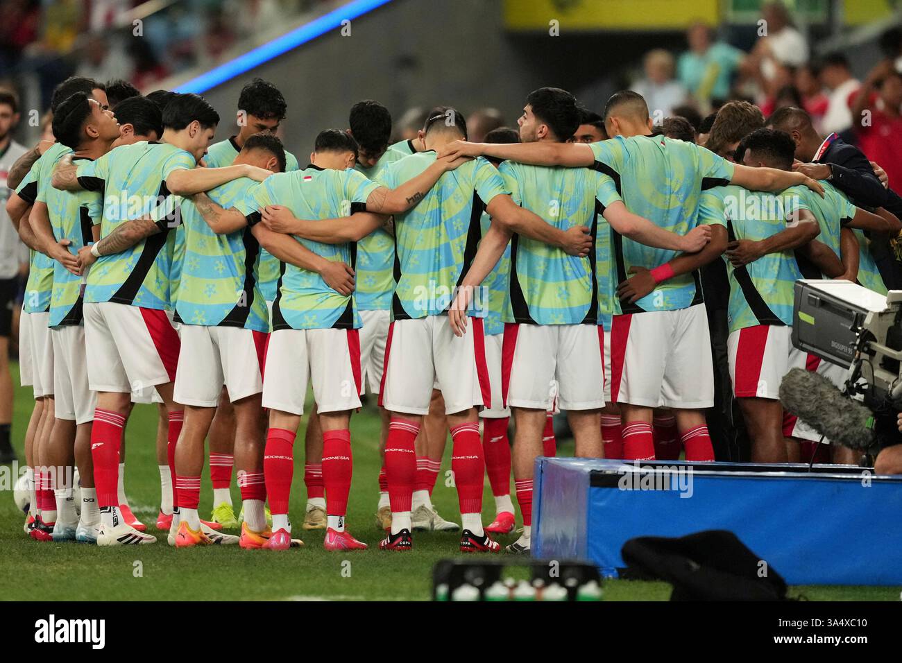 Indonesian players huddle before warming up for their soccer World Cup ...