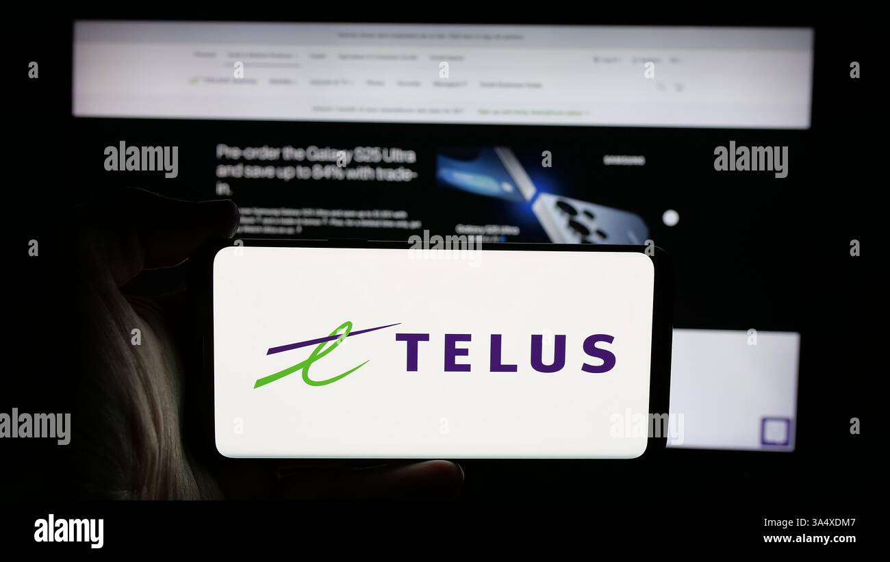 In this photo illustration, a person is holding a cellphone with the logo of Canadian ...