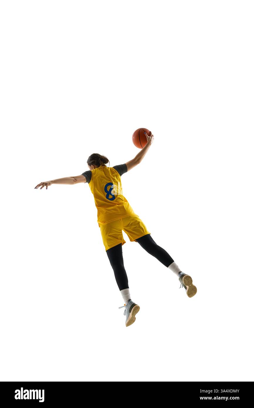Back view of female basketball player in yellow jersey and black shorts ...