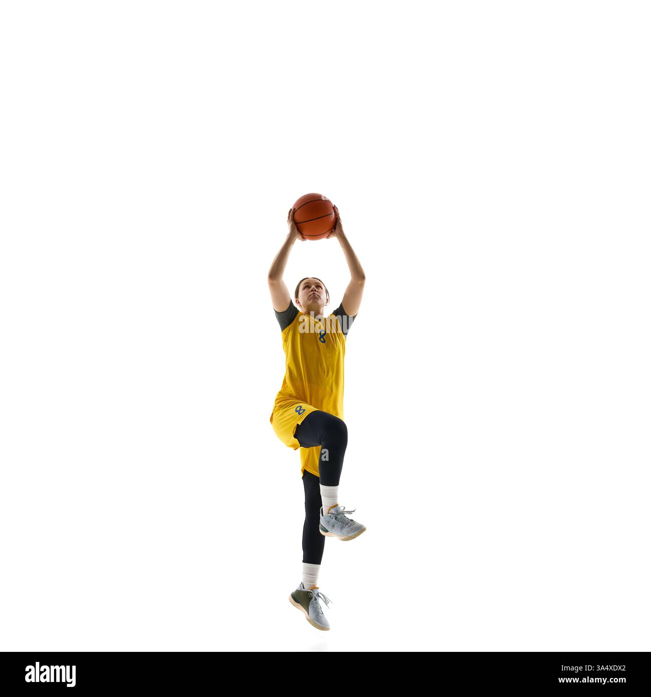 Front view low angle image of focused female basketball player in ...