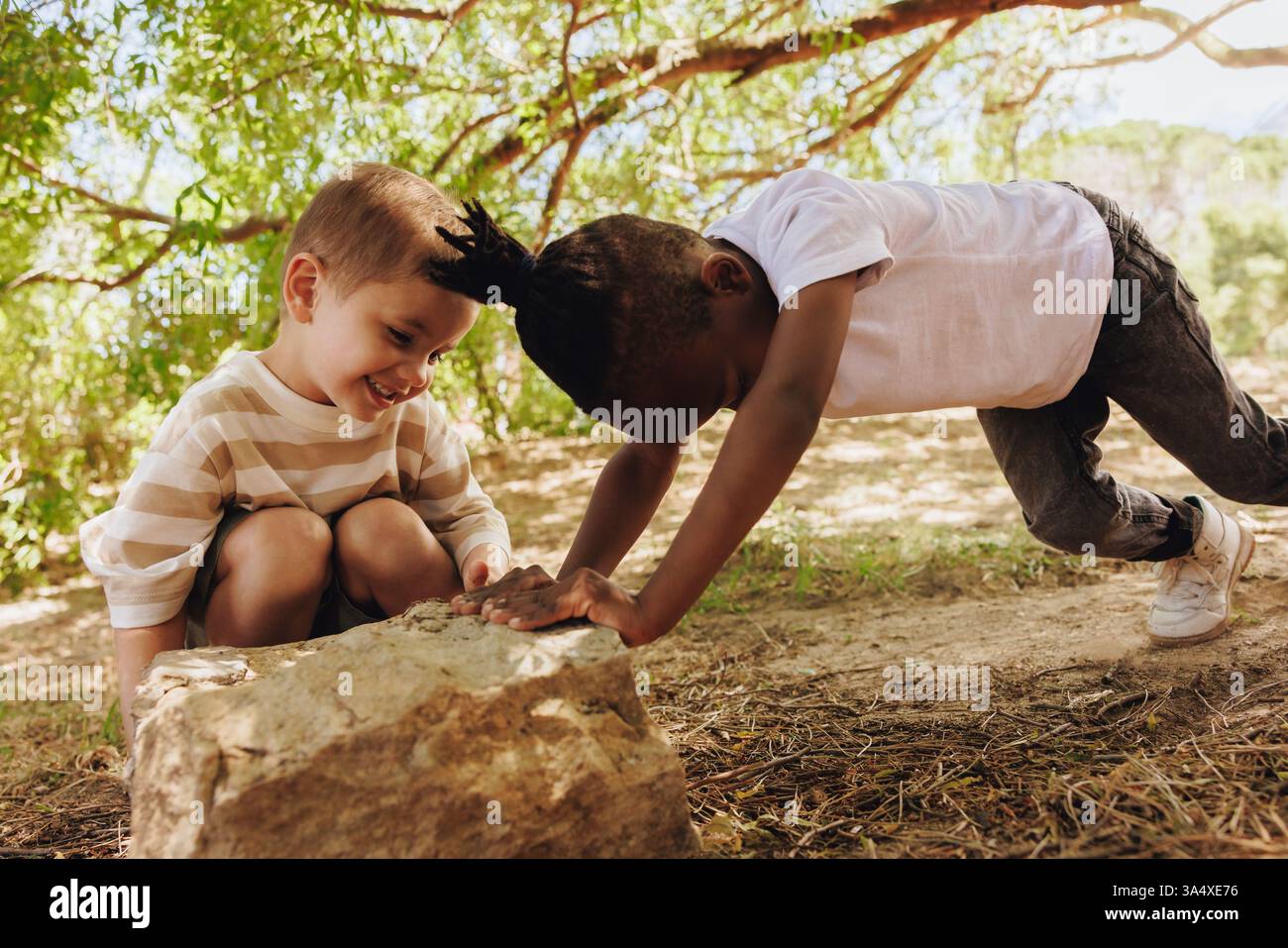 Two children engaged in playful exploration outdoors, fostering ...