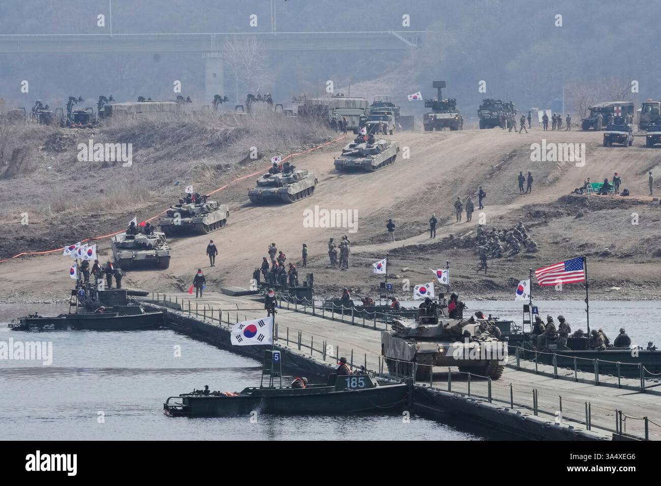 A South Korean army K1E1 tank crosses a floating bridge on the Imjin ...