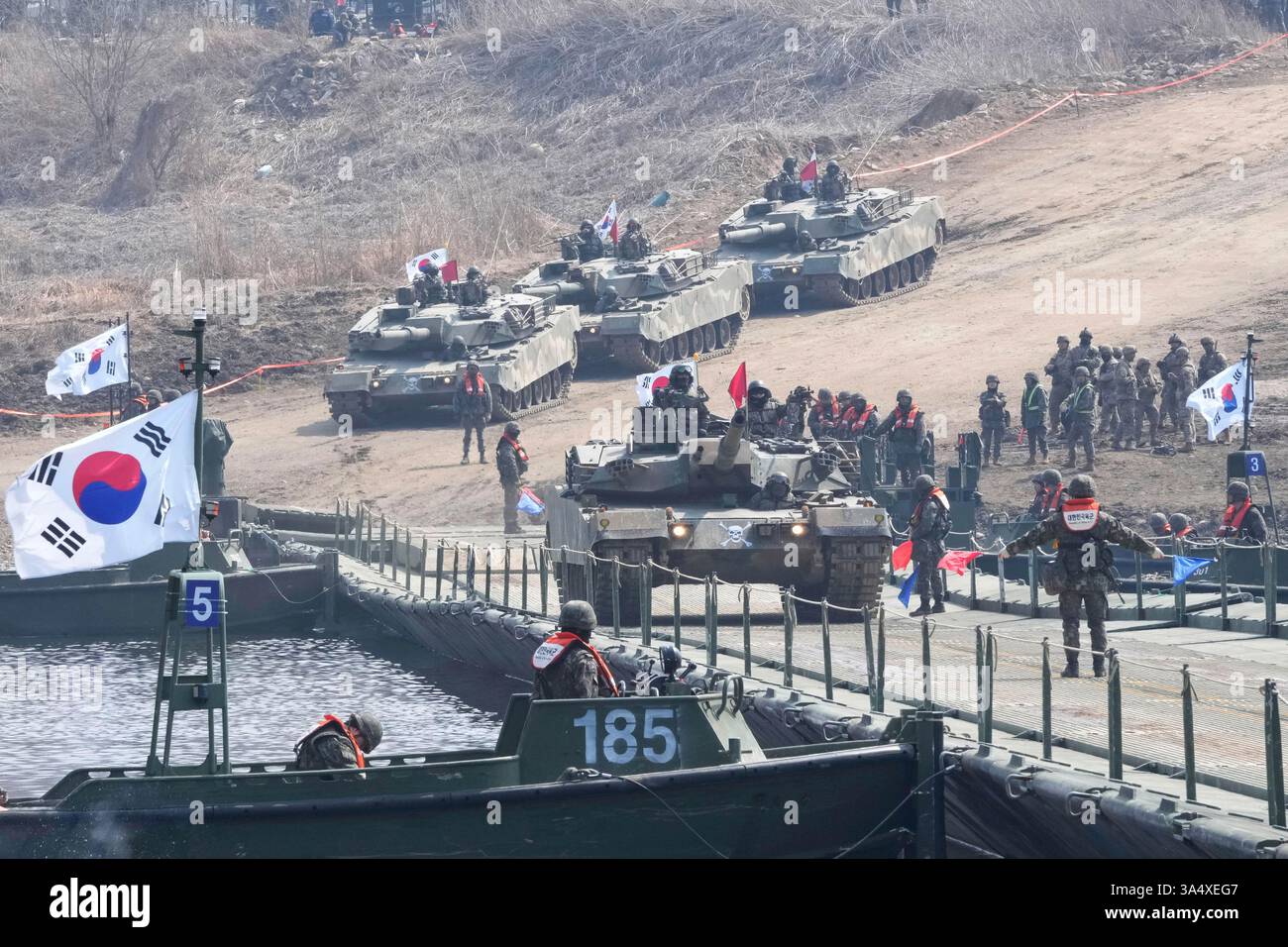 A South Korean army K1E1 tank crosses a floating bridge on the Imjin ...