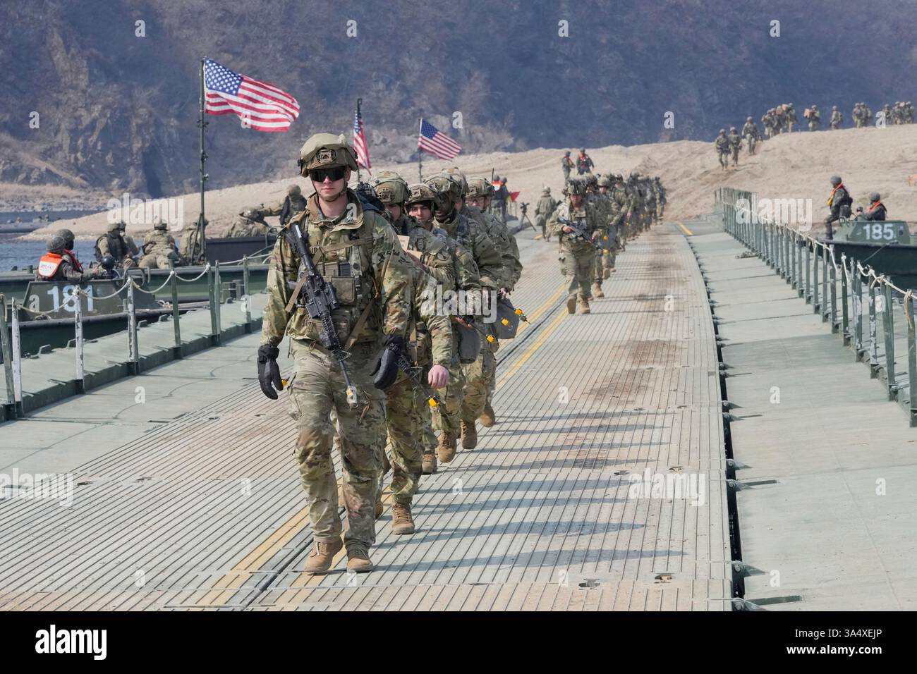 U.S. Army soldiers cross a floating bridge on the Imjin River during a ...
