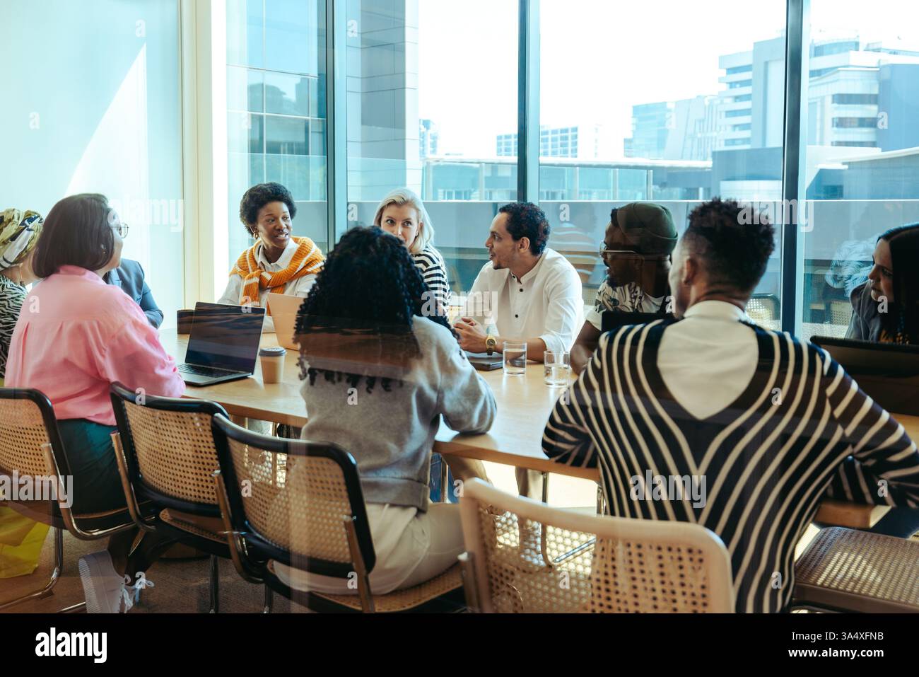A diverse group of professionals engaged in a collaborative meeting in ...