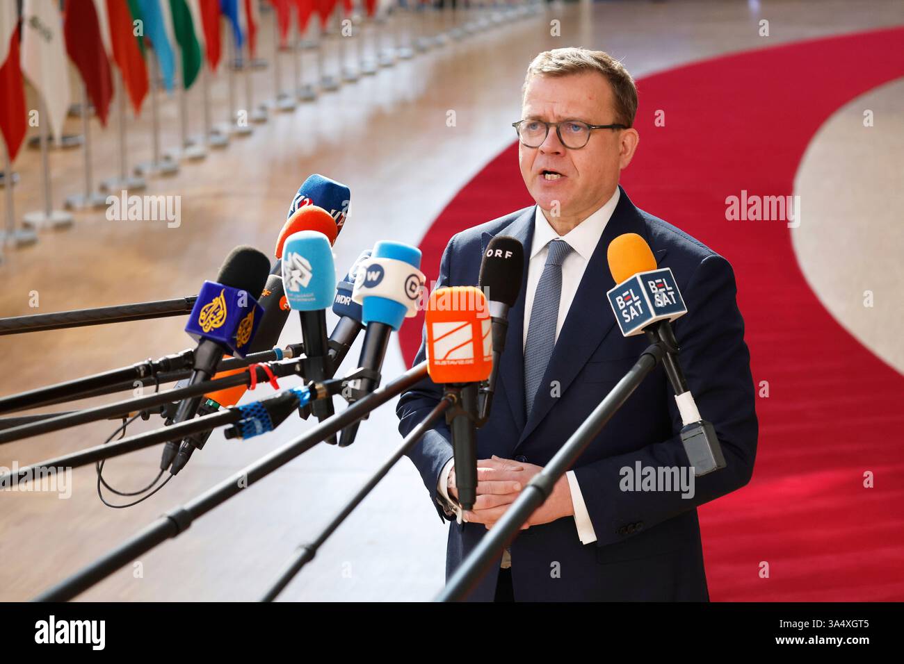 Finland's Prime Minister Petteri Orpo speaks with the media as he arrives for an EU summit at ...