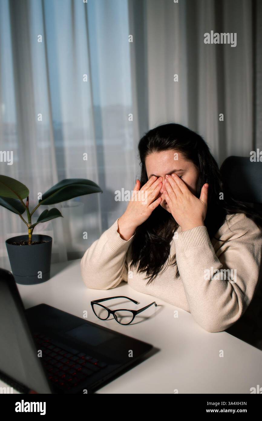 Tired business woman having fatigue and headache during work with ...