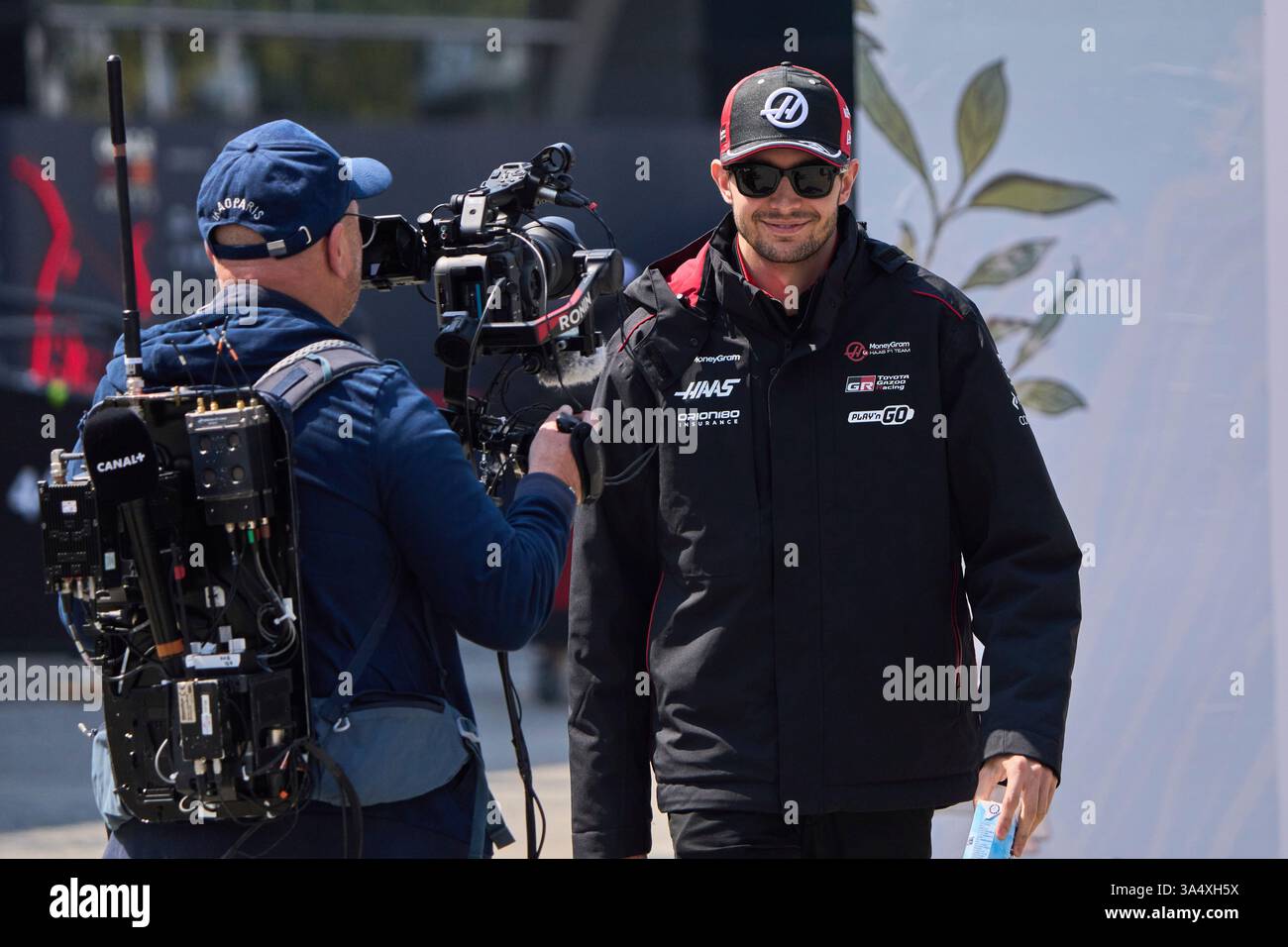 A cameraman films Haas driver Esteban Ocon of France at the Shanghai ...