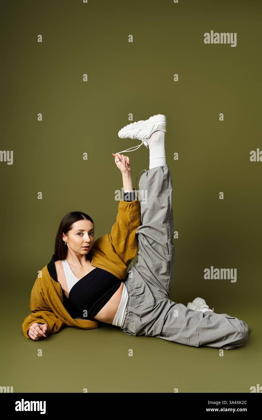 Pretty young woman poses creatively in stylish attire, exuding ...