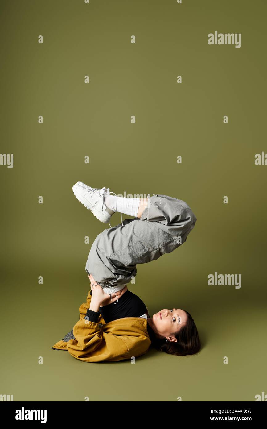 A young woman shows off her unique style while playfully balancing on ...