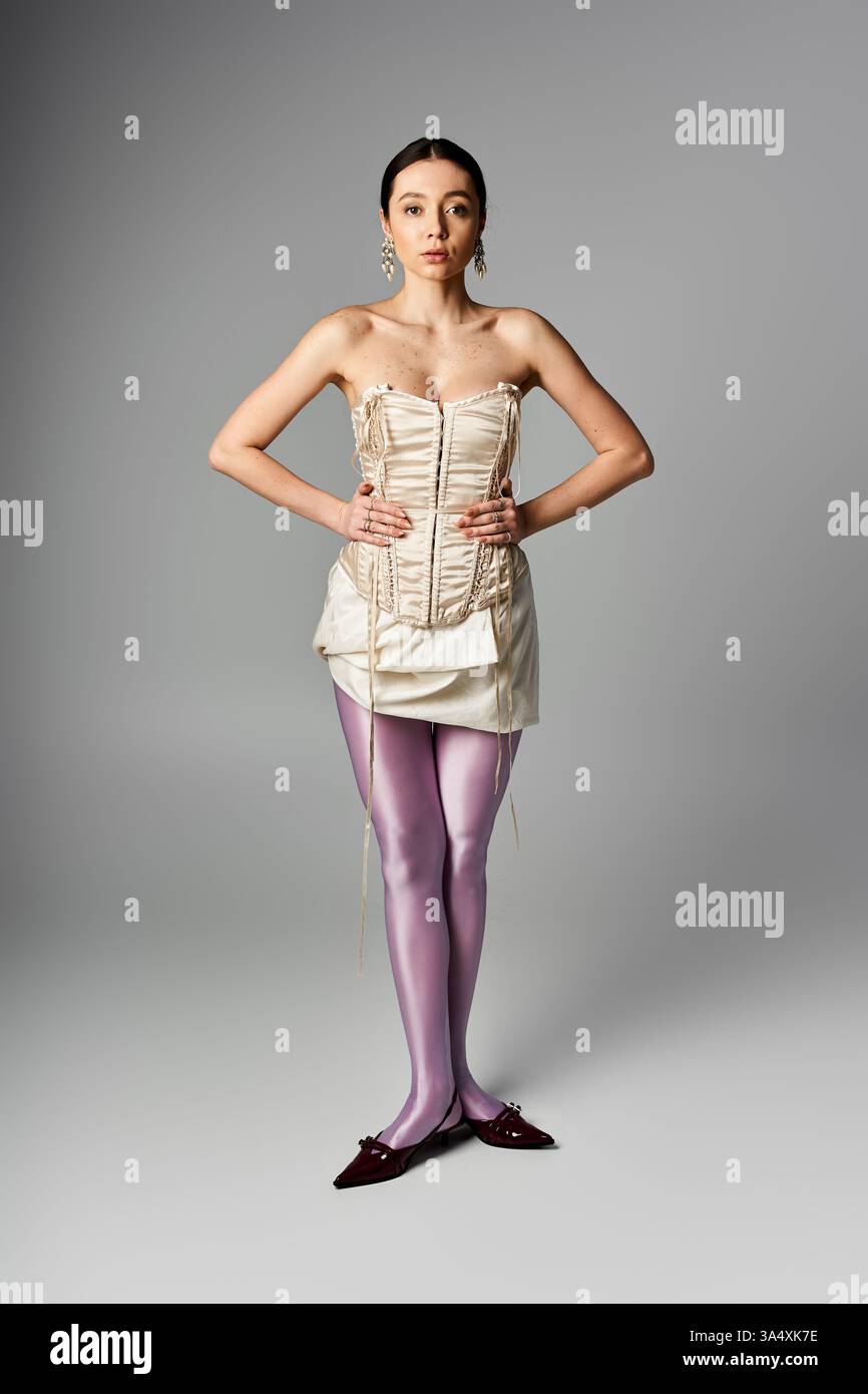 A young pretty woman stands confidently in a chic outfit that ...