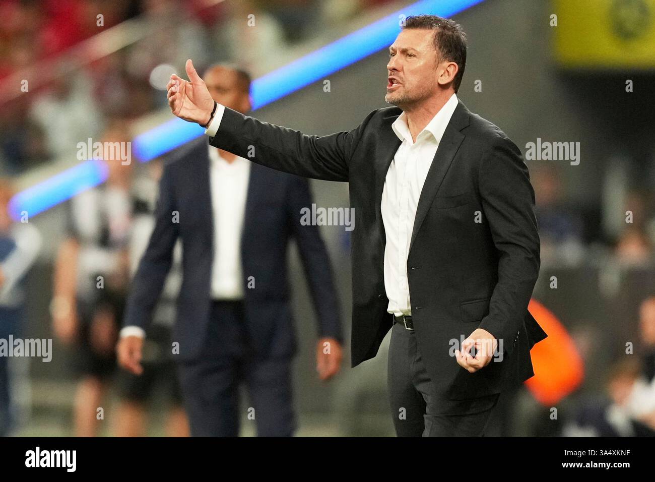 Australia's coach Tony Popovic instructs his players during their ...