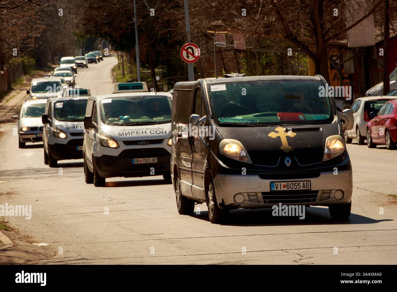 A convoy of vehicles transporting the bodies of the victims of a ...