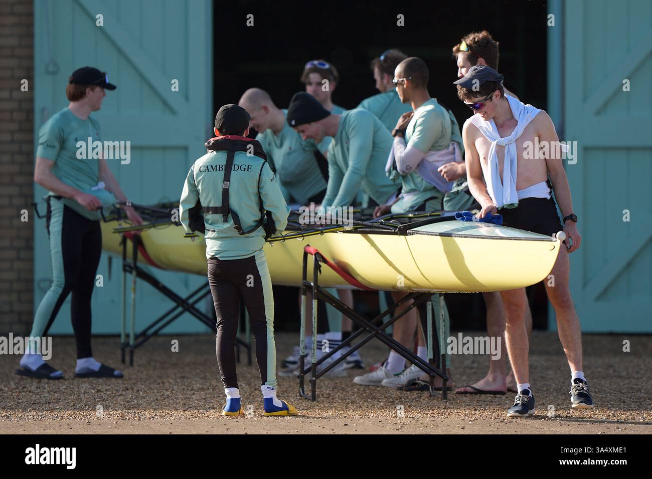 Cambridge University dry off their boat after a training session on the ...