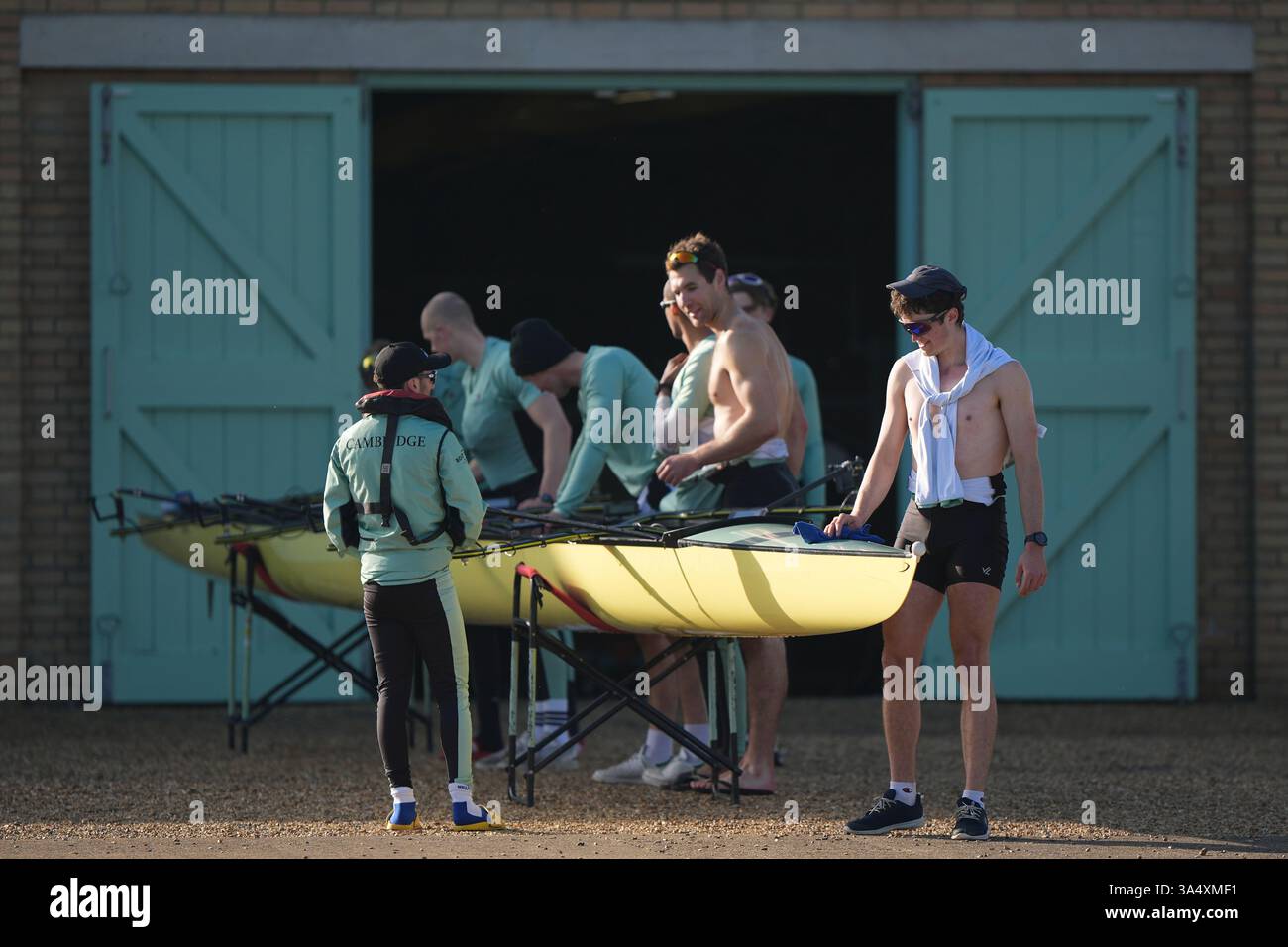 Cambridge University dry off their boat after a training session on the ...