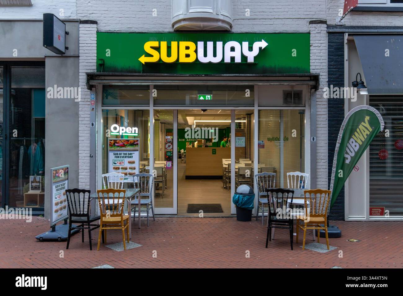 Subway restaurant front and an empty terrace with logo. Subway is an ...