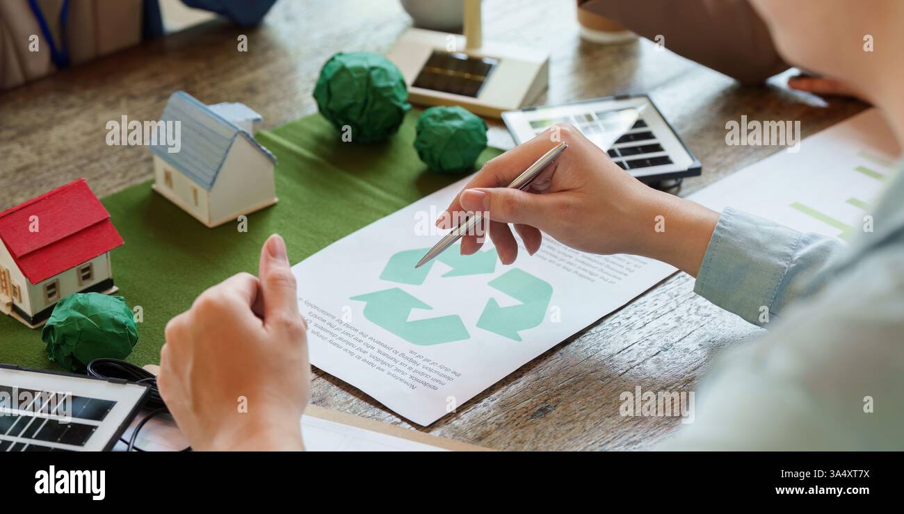 Recycling and Sustainable Development. A team discussing recycling strategies using eco-friendly ...