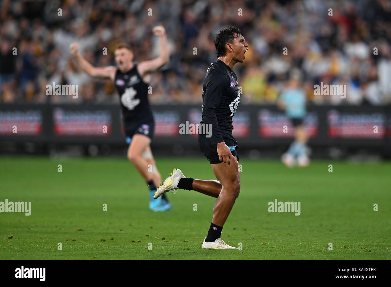 Jesse Motlop of Carlton (right) reacts after kicking a goal during the ...