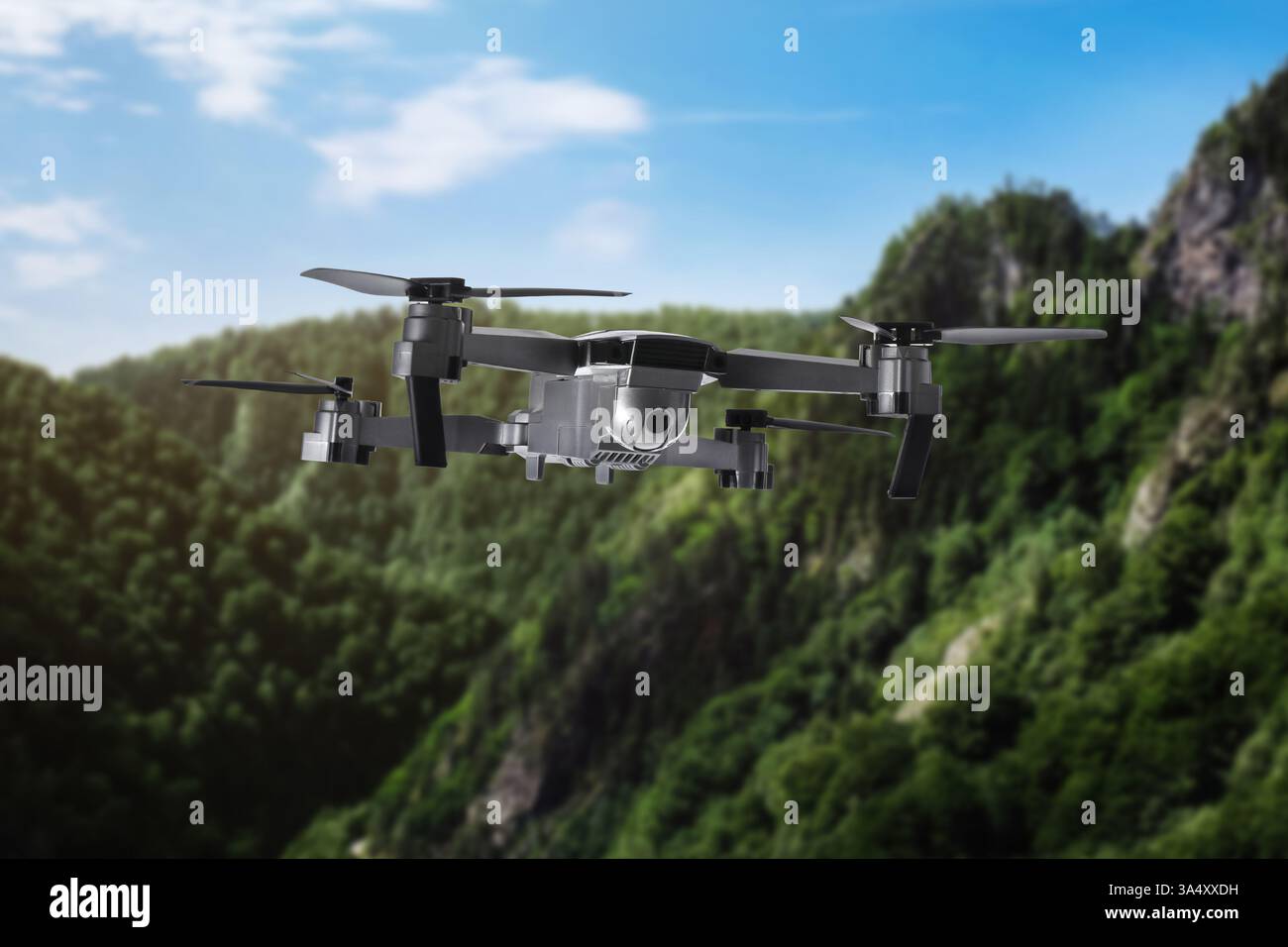 Drone with camera flying in mountains. Unmanned aerial vehicle for ...