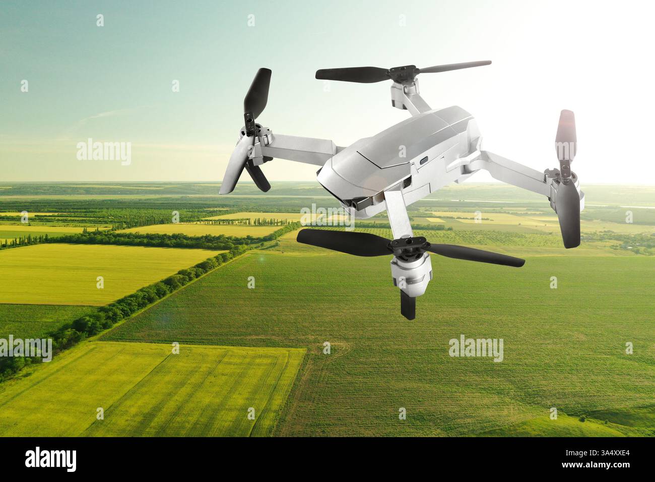 Drone with camera flying over fields. Unmanned aerial vehicle for ...