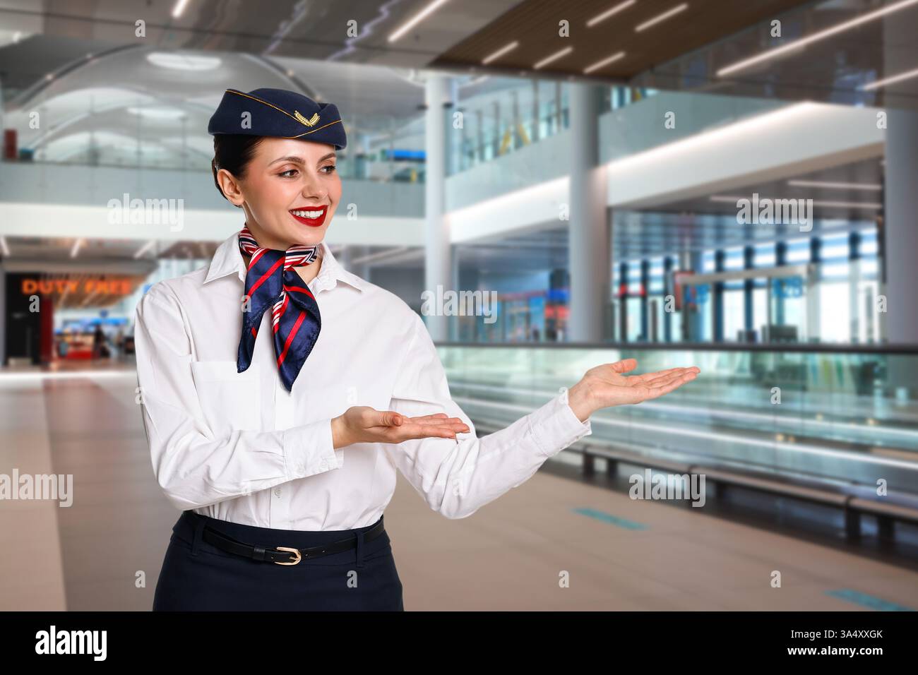 Smiling stewardess welcoming passengers to airport terminal Stock Photo ...