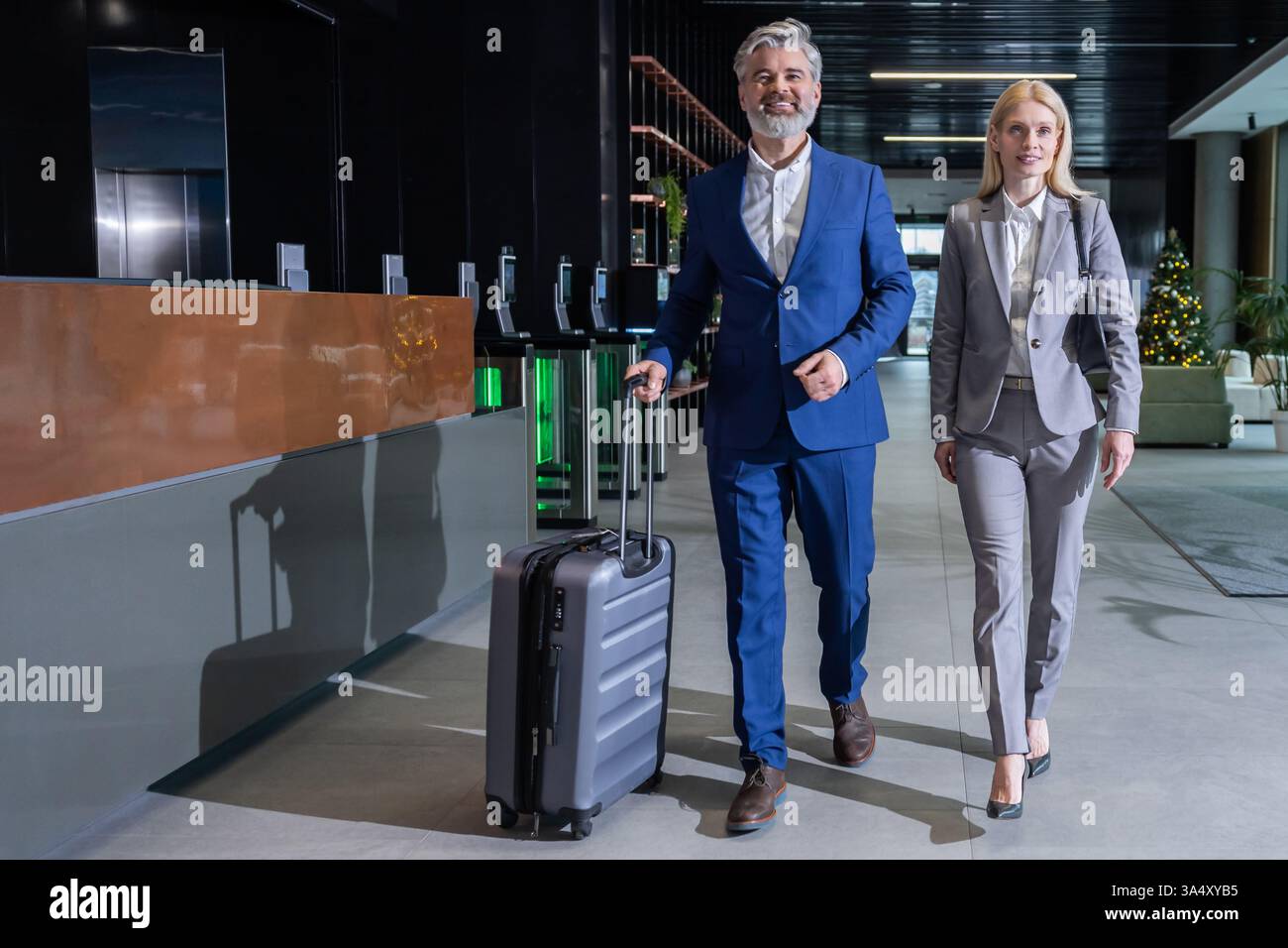 Business owner meeting a partner in the airport and going to the exit ...