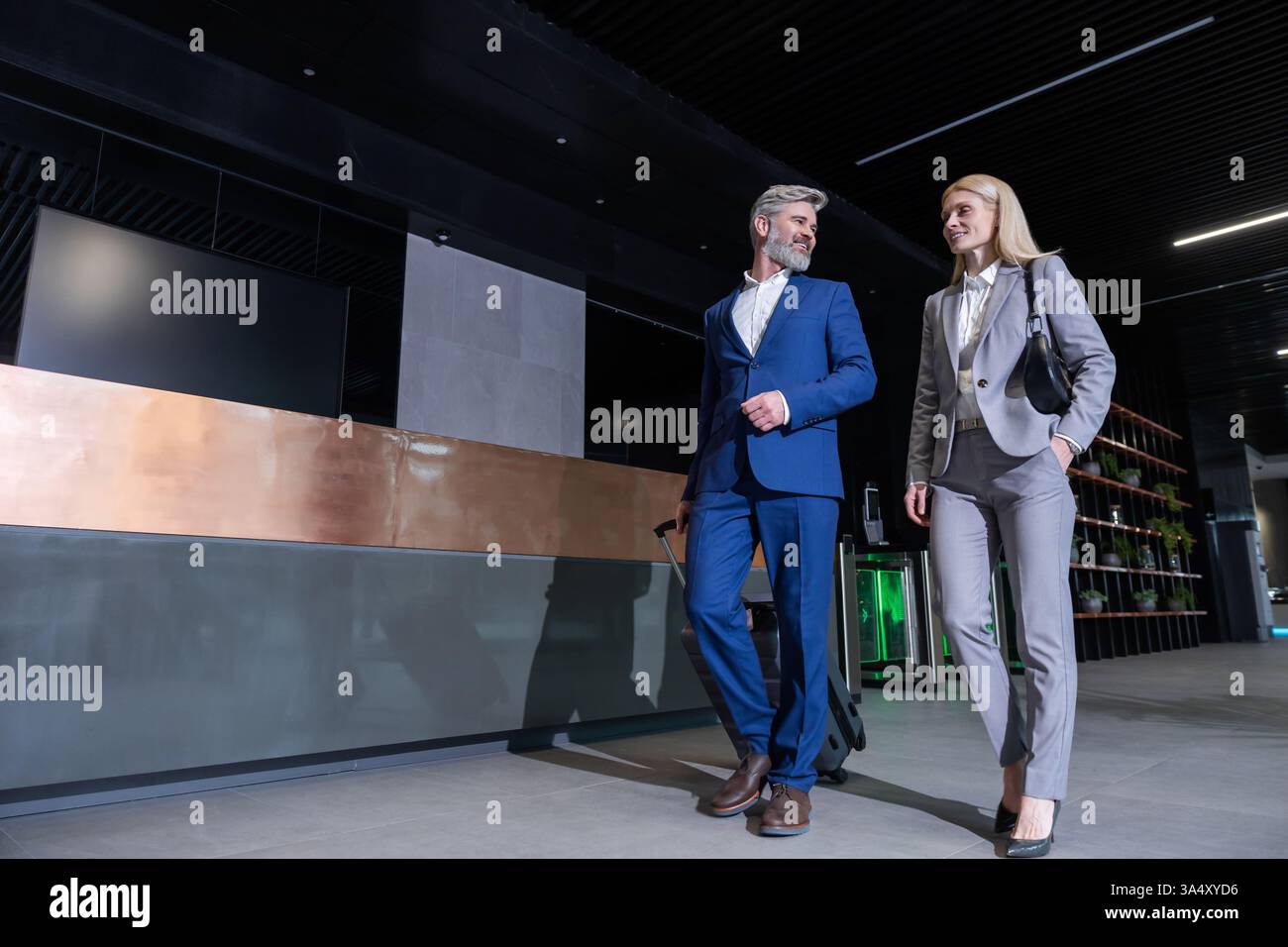 Two people walking together to the airport exit after arrival Stock ...