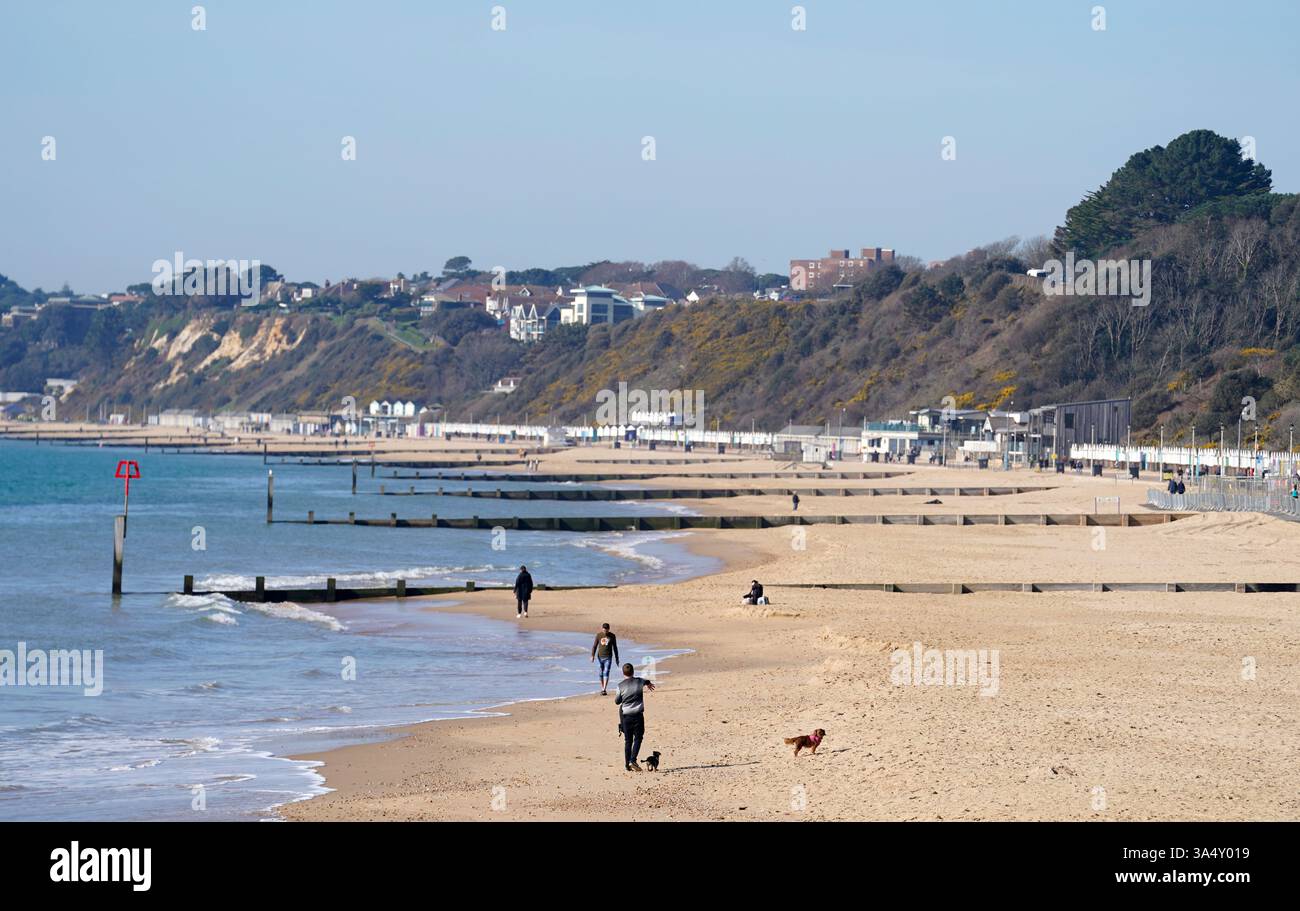 People walk along Bournemouth Beach in Dorset. The spring equinox, the ...