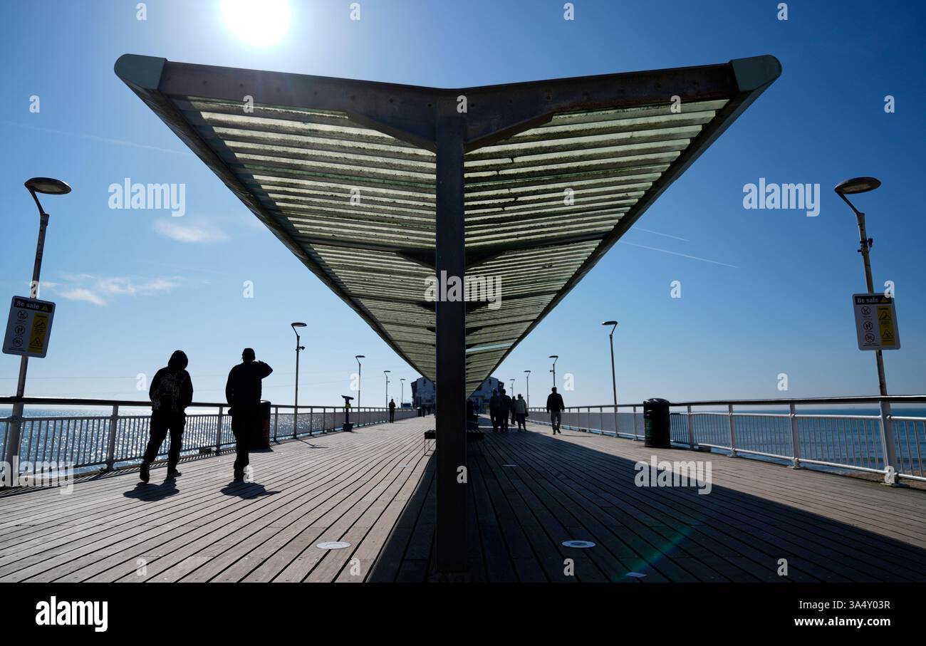 People walk along Bournemouth Pier in Dorset. The spring equinox, the ...