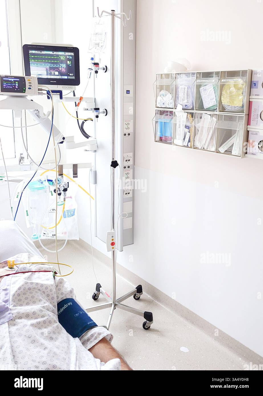 Unrecognizable Caucasian male patient arm with blood pressure monitor ...